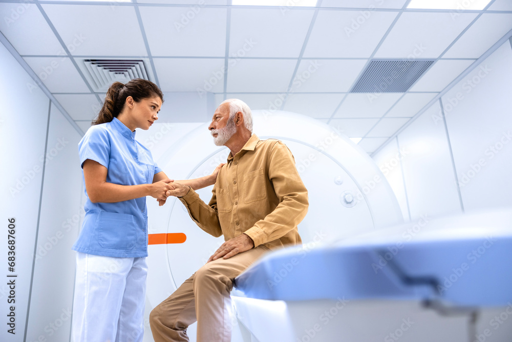Doctor preparing and encouraging senior man before MRI scan or CT ...