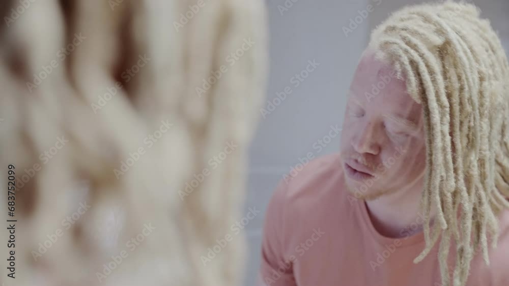 Reflection Of An Albino Man With Dreadlock Hair Looking At Himself In
