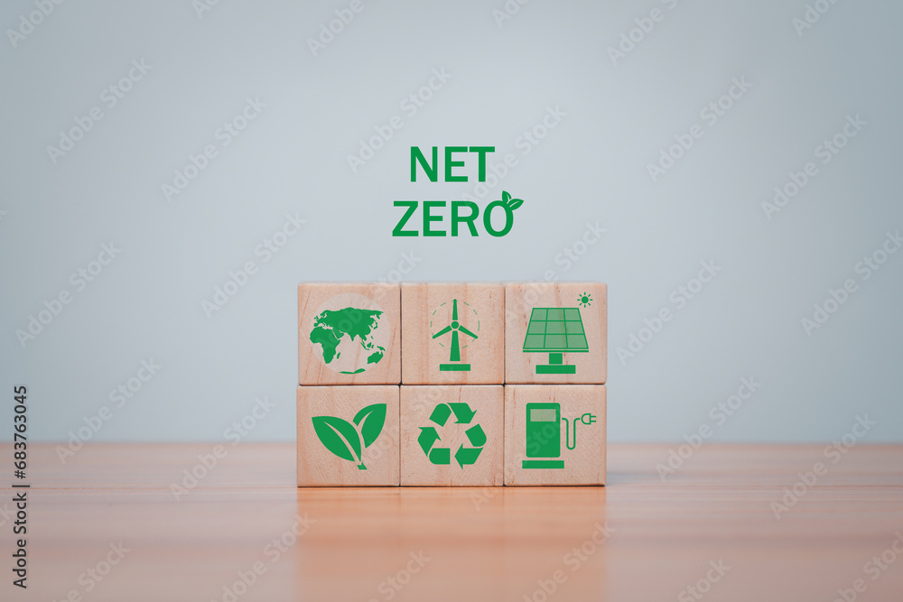 Wooden cubes with green net zero icon and green icon on grey background ...