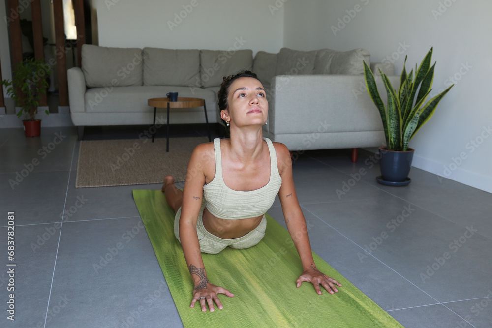 Young middle eastern woman practicing hatha yoga at home. Yogini doing ...