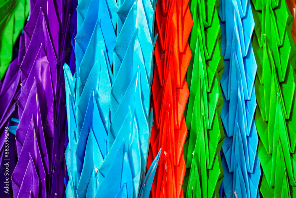 Strings of colourful folded origami paper cranes in Hiroshima peace ...