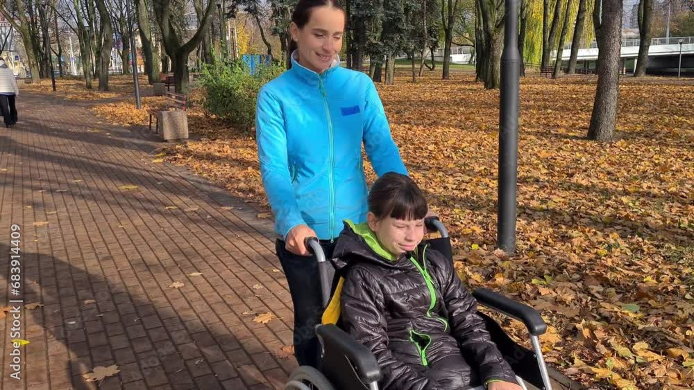 Vidéo Stock Mom with her little disabled daughter in a wheelchair in ...