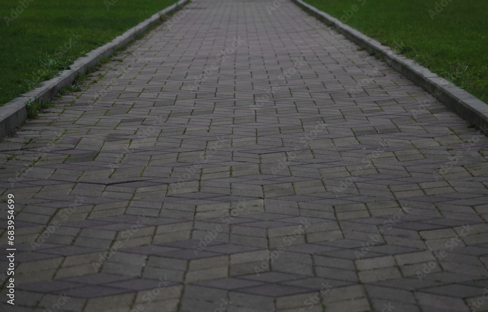 Path in park. Tile trail through park. Details of pedestrian zone ...