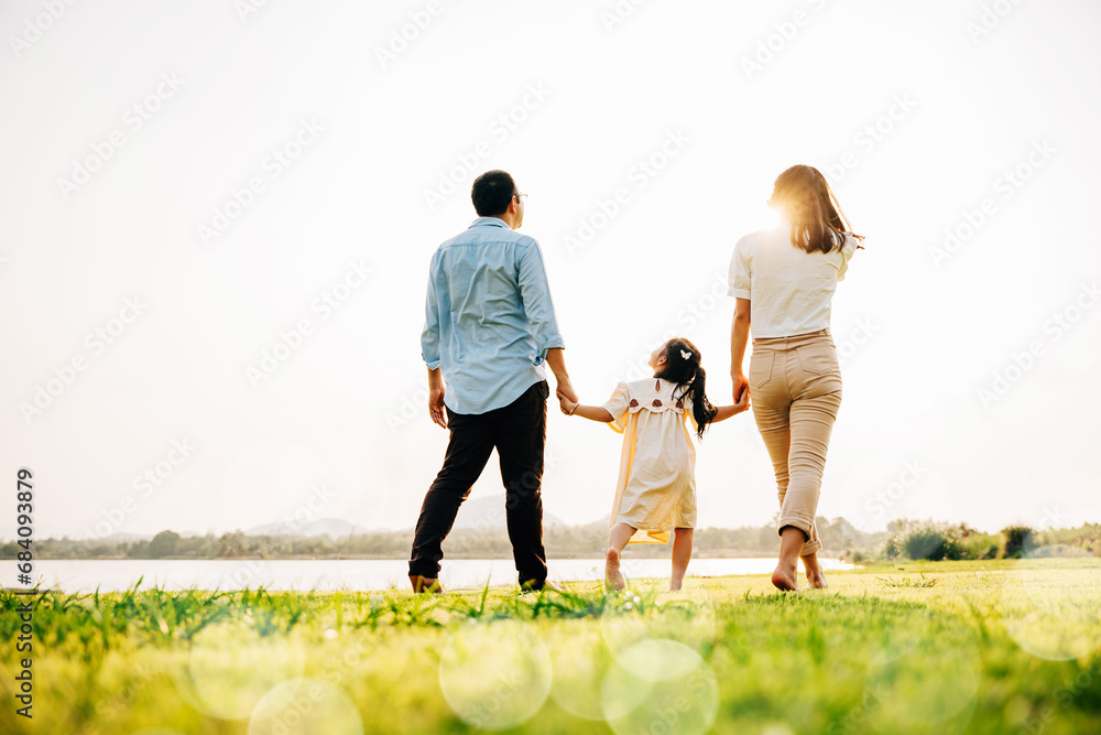 Happy Japanese family walking together in a scenic garden, with a ...