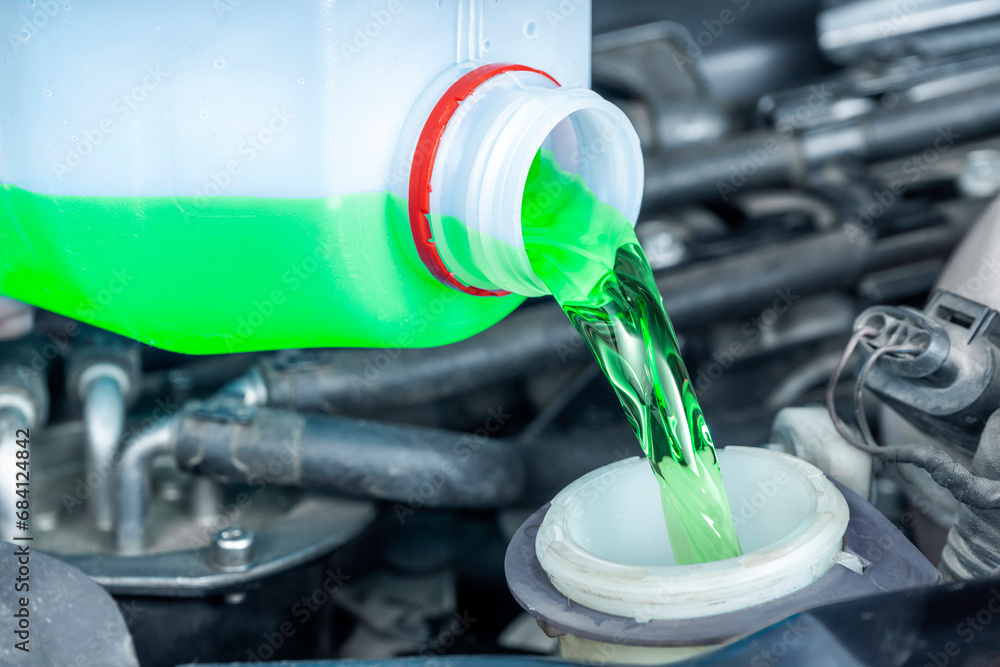 Poster Close-up of pouring coolant antifreeze fluid in workshop – Wall ...