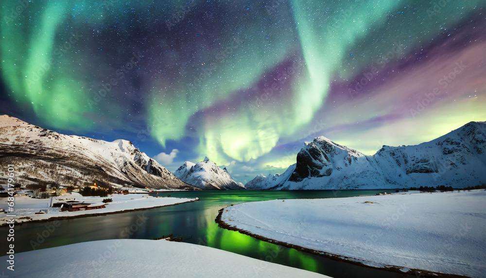 northern lights aurora borealis in the sky over snow covered mountains ...