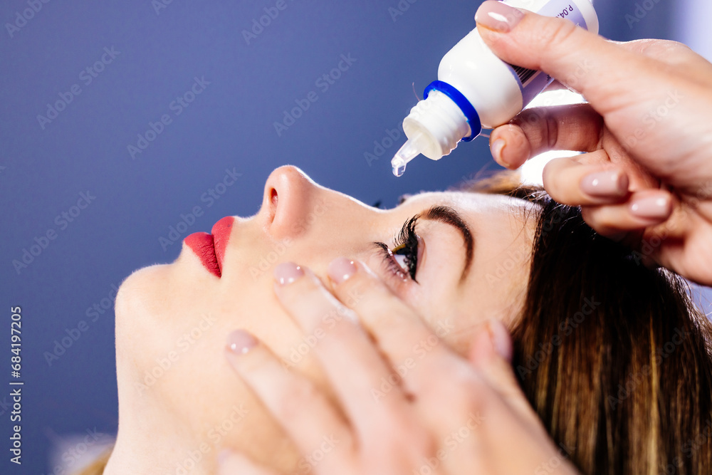 Cropped shot of a woman dripping her eyes with medicinal drops natural ...
