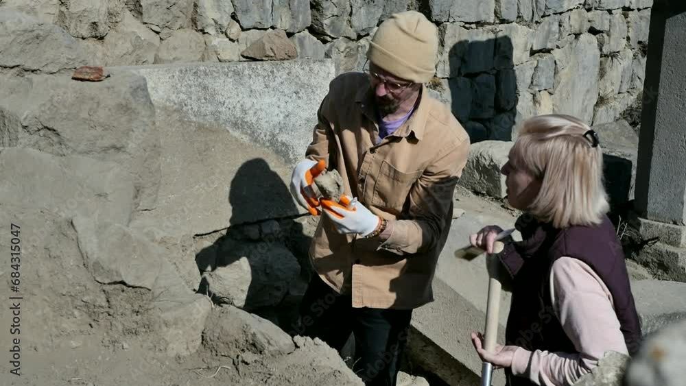 Scientists, a man and a woman, archaeologists discovered the bone ...