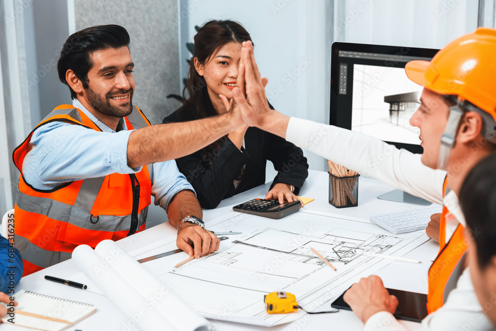 Diverse group of civil engineer and client celebrate and high five ...