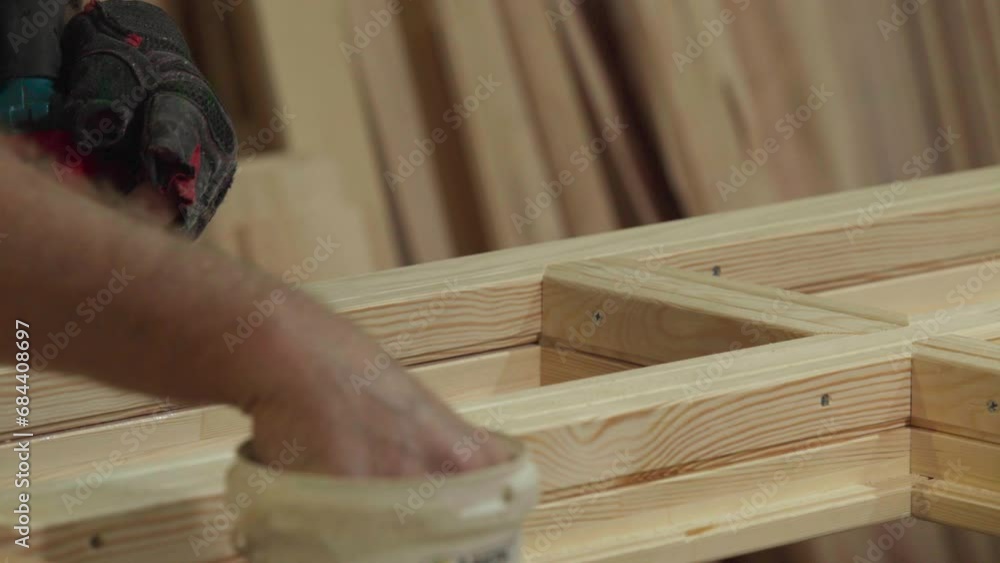 Craftsman Uses Instrument To Drill Fastener Into Piece Of Wood ...