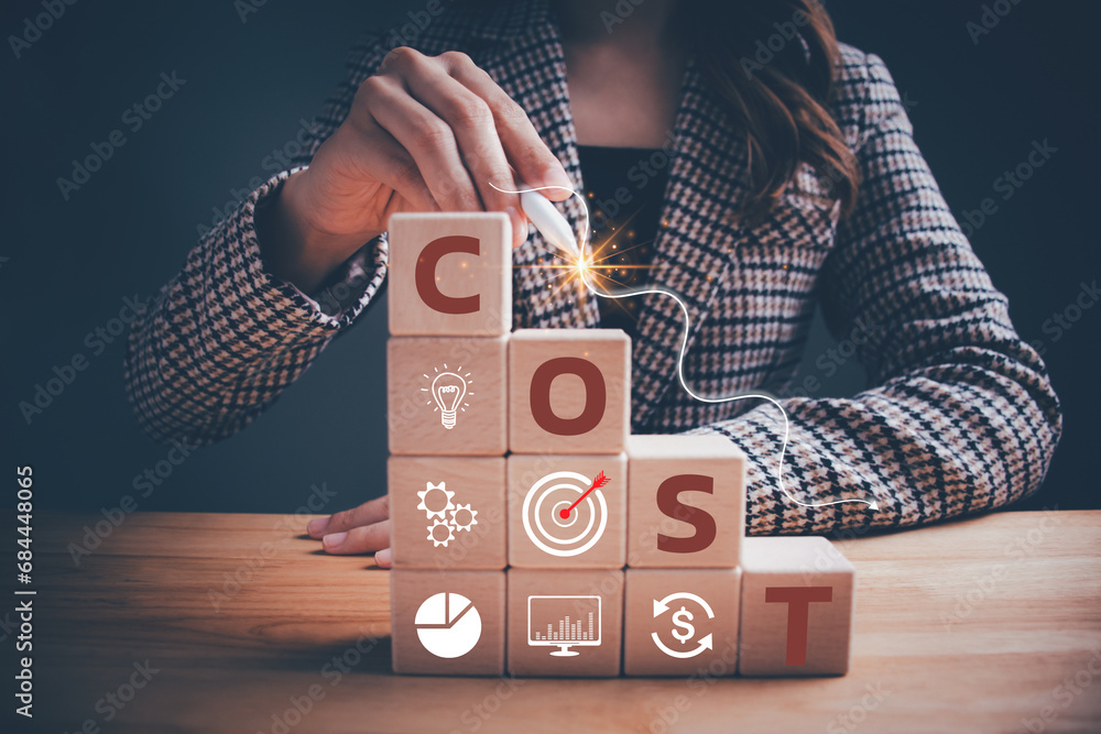 "COST" text on descending step stairs of wooden blocks. Help businesses ...
