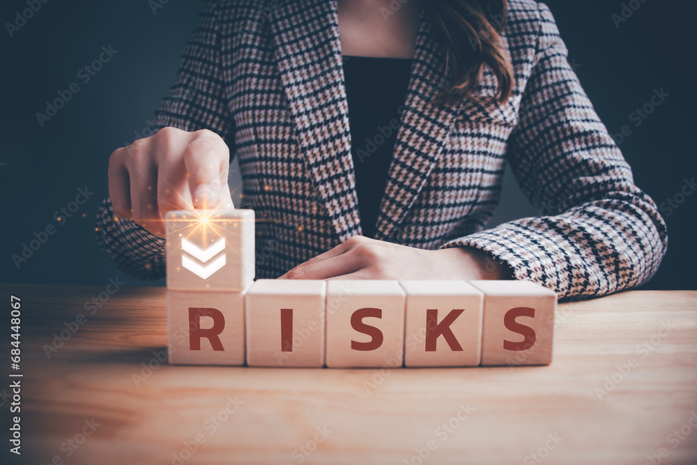 Businesswoman with word "RISK" on wooden blocks cubes and arrow ...
