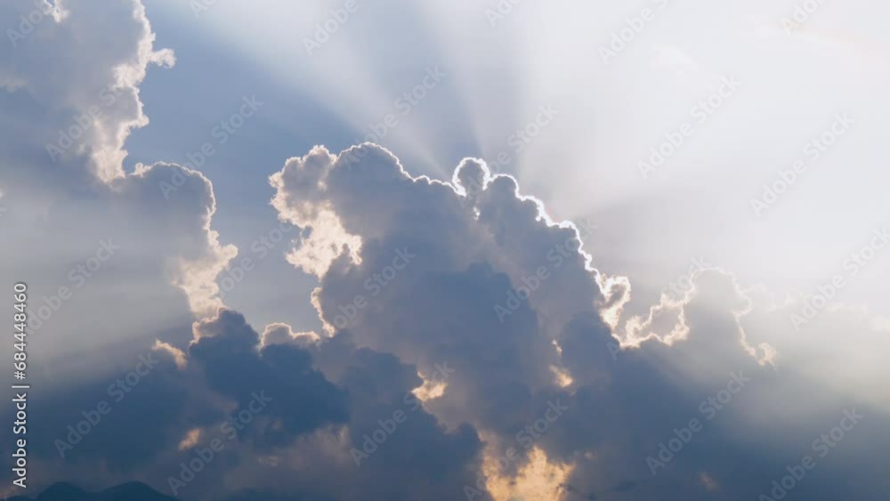 Sun blocked by cloud and emitting rays beyond clouds from corner feels ...