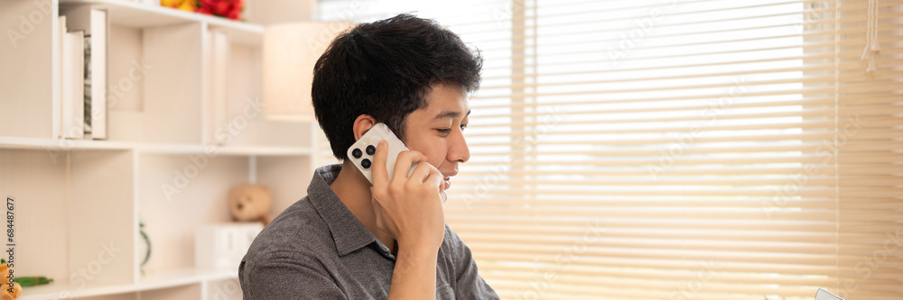 Businessman talks on the phone with a customer, Man sitting and working ...