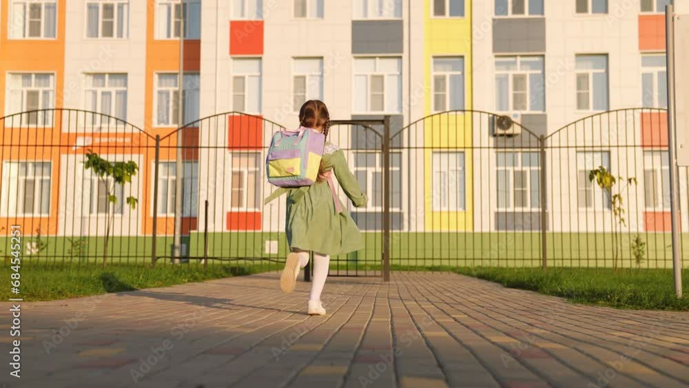 little girl with school backpack runs with her feet way to school ...