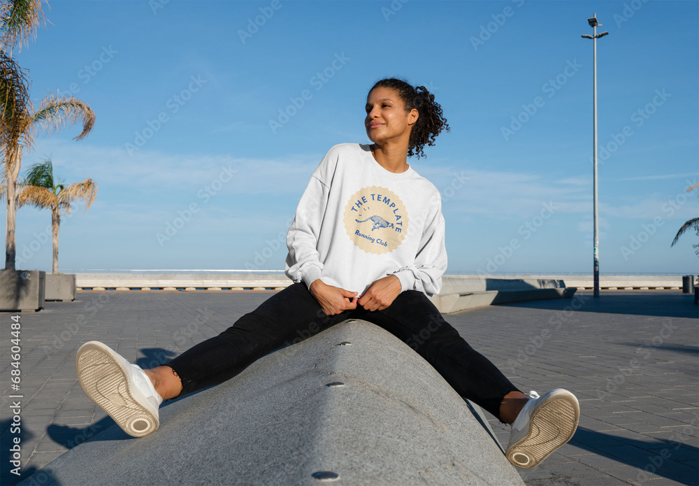 Mockup of woman wearing customizable sweatshirt on wall, legs apart ...