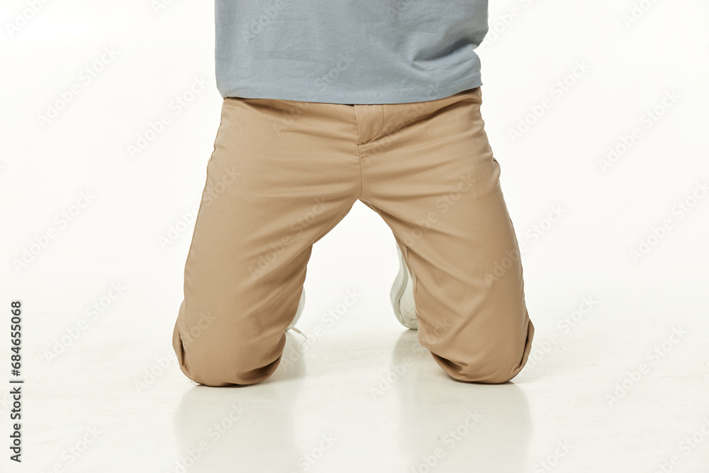 casual man standing on his knees on white studio background Stock Photo ...
