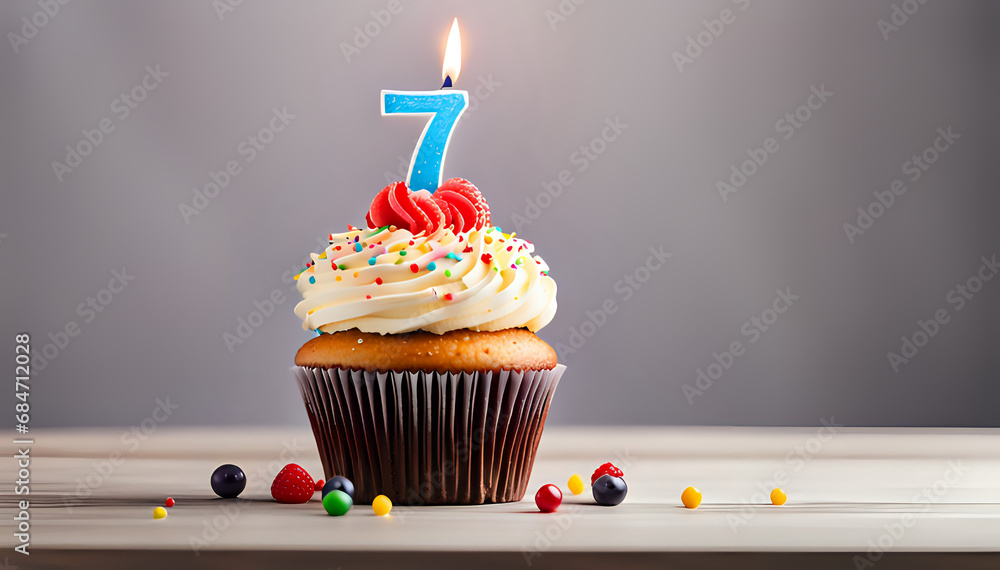Birthday cupcake with lit birthday candle Number seven for seven years ...