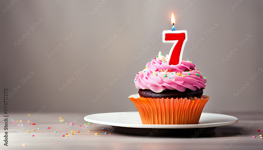 Birthday cupcake with lit birthday candle Number seven for seven years ...