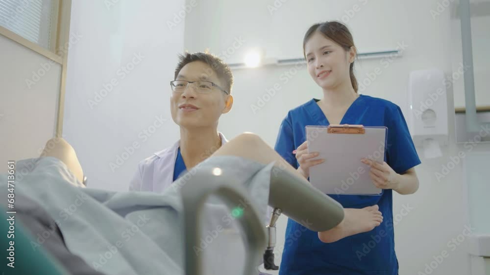 Male asian doctor doing internal examination on female patient at ...