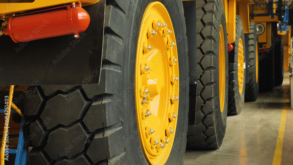 Assembly line of large dump trucks. Finished dump trucks stand in a row ...