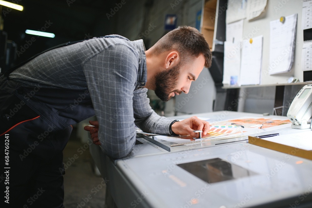 Printing house interior with modern offset print machine and operator ...
