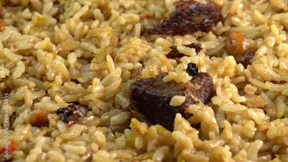 Uzbek pilaf rotates side view. Traditional East Asian dish with ...
