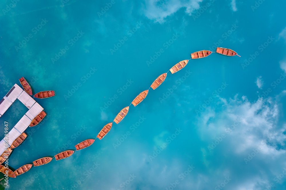 An artistic, perpendicular view of an axis shape made of wooden boats ...