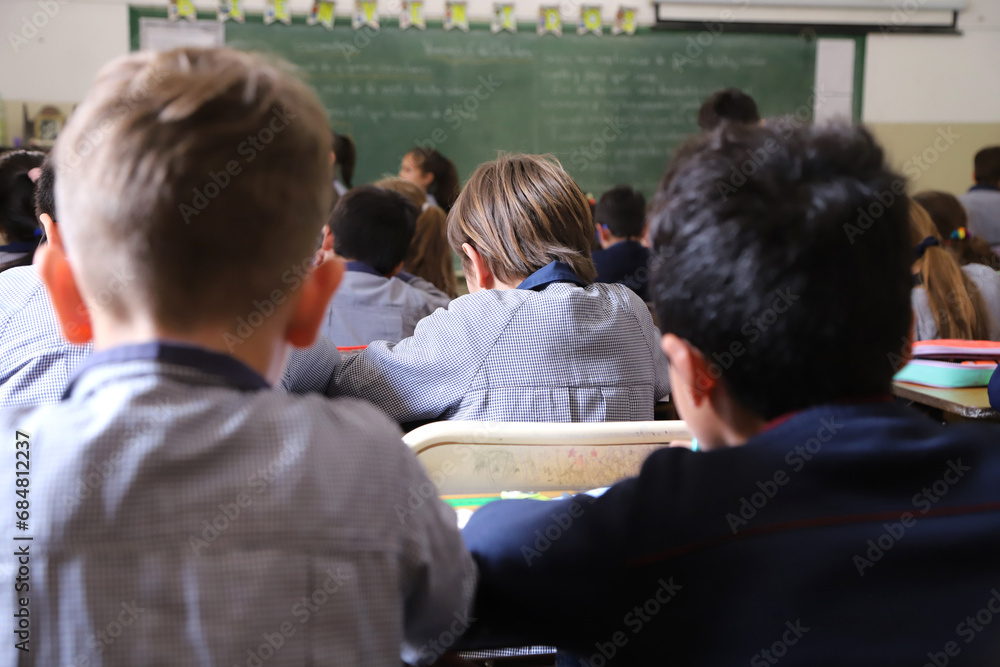 Primary school with children studying.Students in class copying text ...