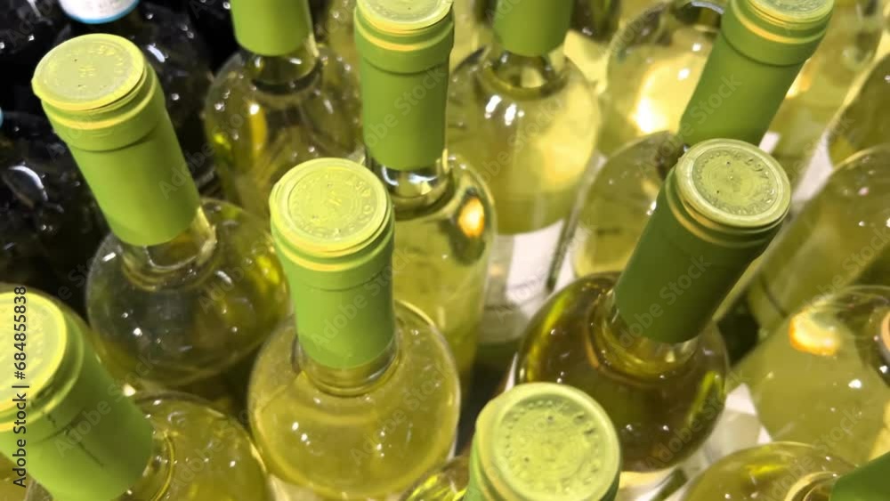 Top down view of white wine bottles line up on the shelf of an ABC ...