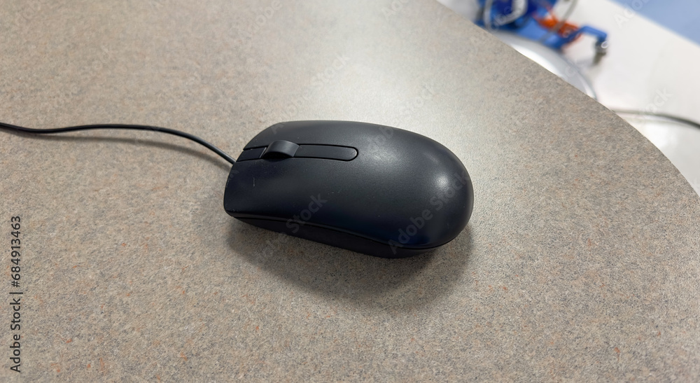 electronic mouse on a desk, sleek design and buttons, symbolizing ...
