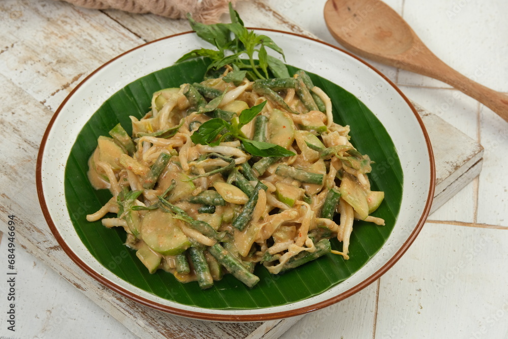 Karedok or keredok is raw vegetables salad covered in spicy peanut ...