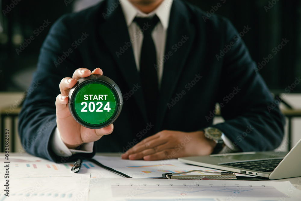Businessman holding the green button with text start 2024 idea for 2024 ...