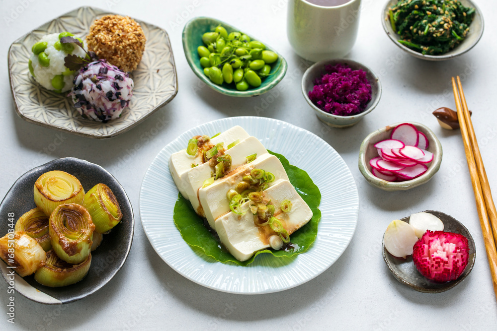 Japanese lunch with silken tofu, onigiri, spinach gomae, miso leeks ad ...