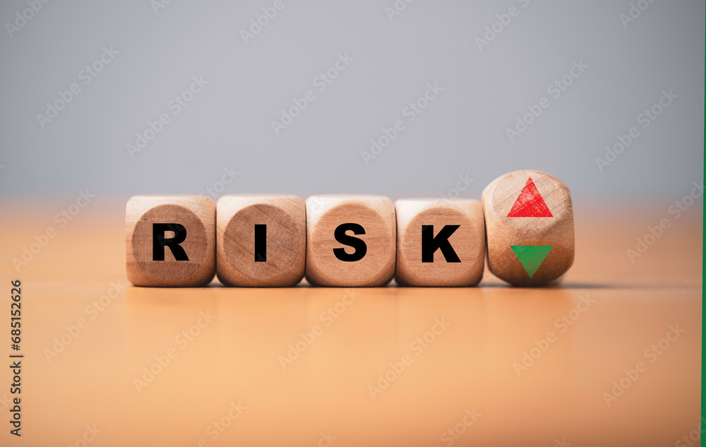 Risk wording with up and down arrow on wooden block cube for high and ...