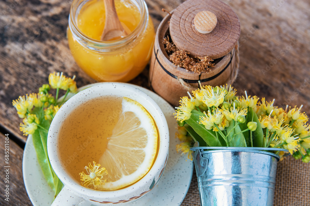 cup of herbal linden tea with lemon slice and honey. Flu treatment and ...