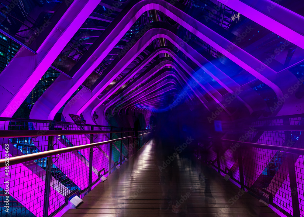 Illuminated pedestrian bridge at a station at night, Jakarta, Indonesia ...