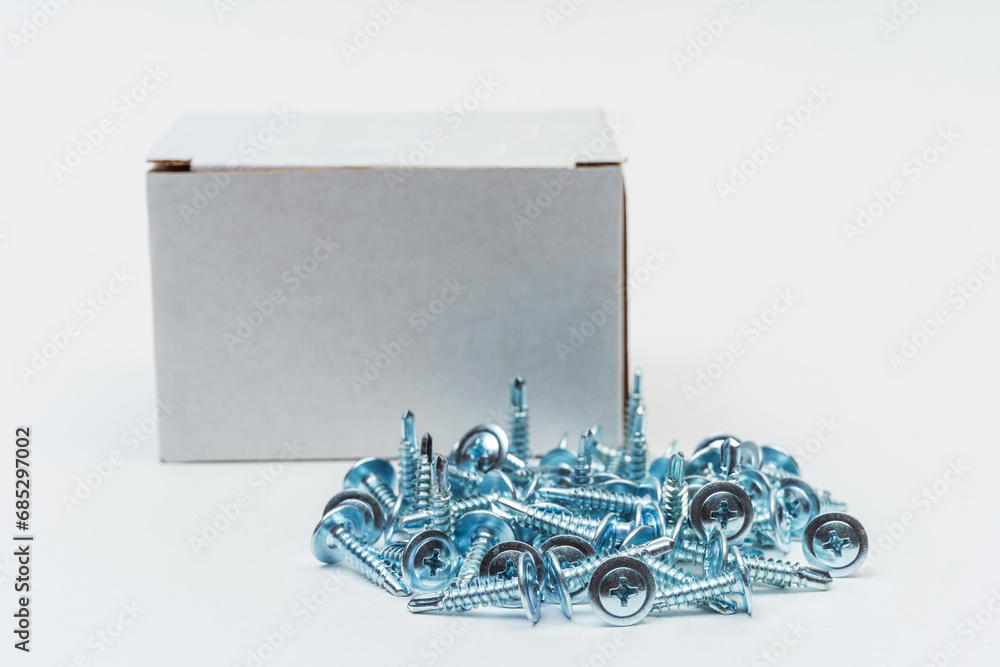 screws with packaging on a white background. photo of self-tapping ...