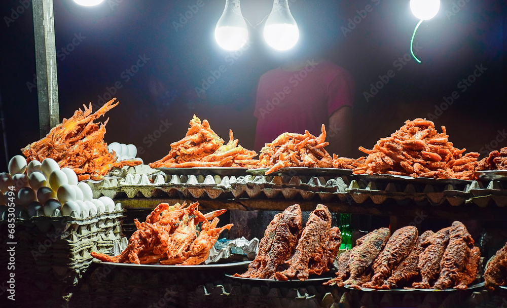Street food made with different types of Ocean fishes, crabs, octopus ...