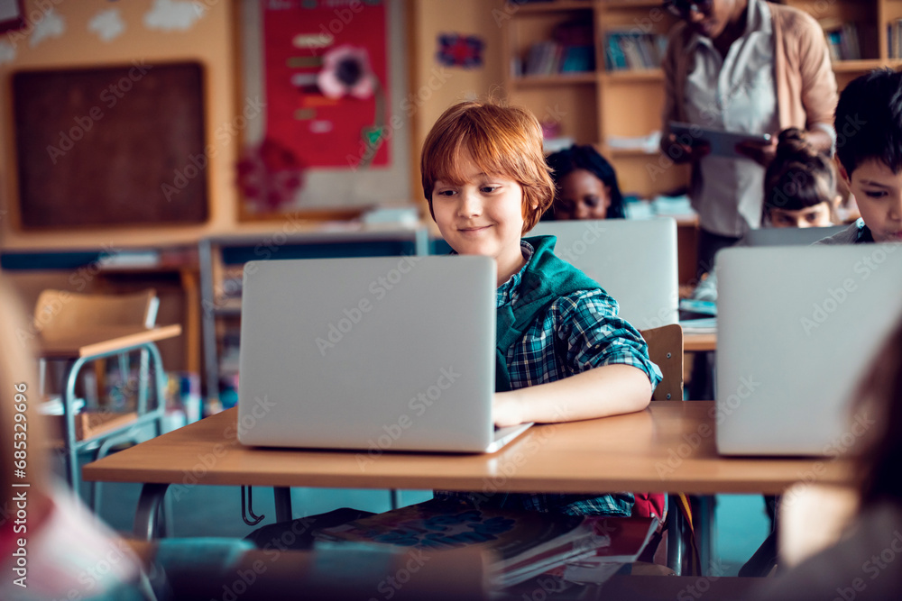 Children having computer class using laptop in classroom Stock Photo ...