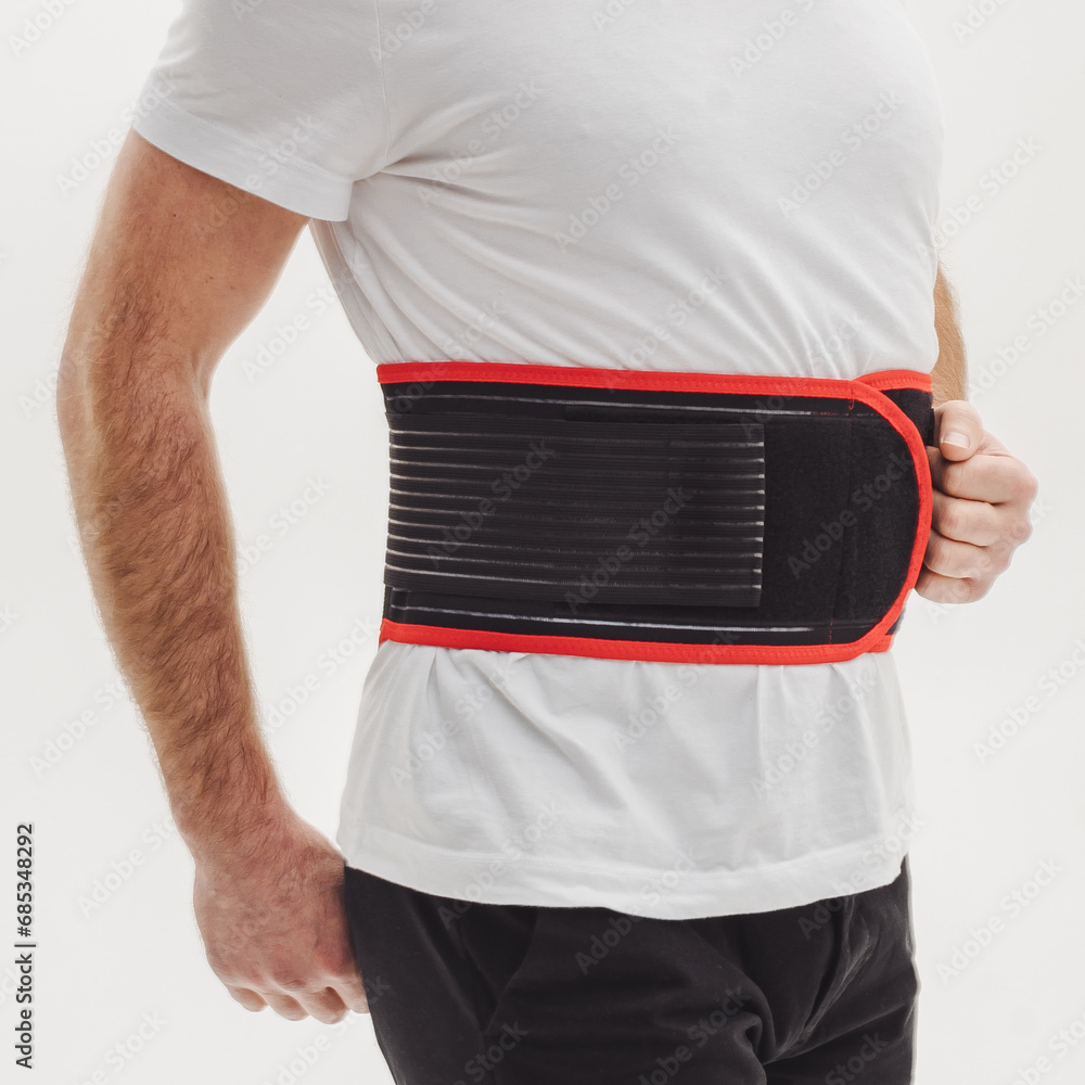 Lumbar brace on the human body isolated on a white background. Trauma ...
