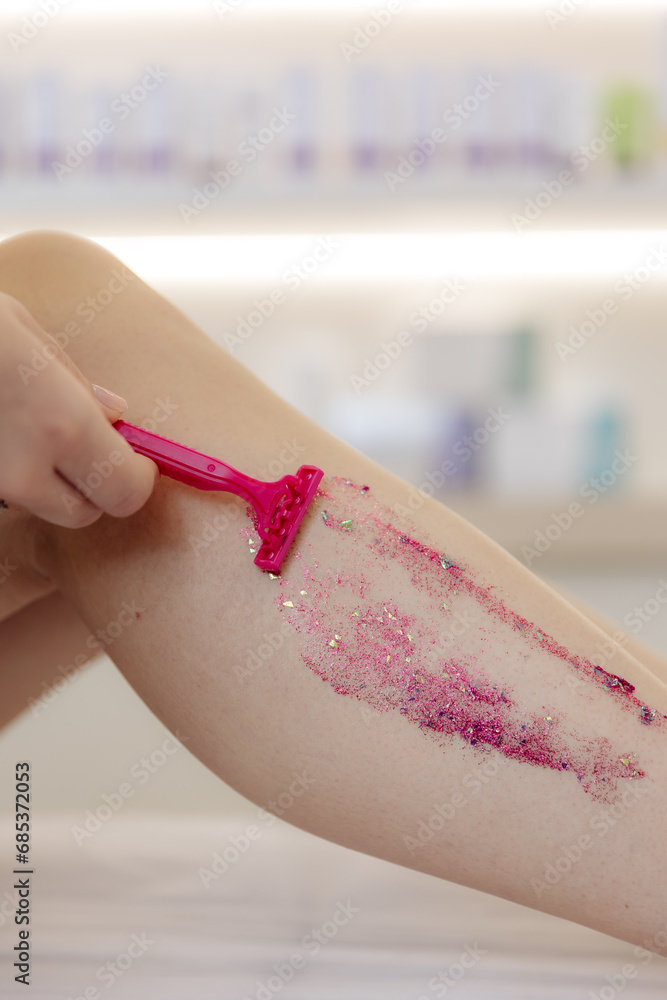 the concept of shaving hair on the skin of women's legs. A photo of a ...