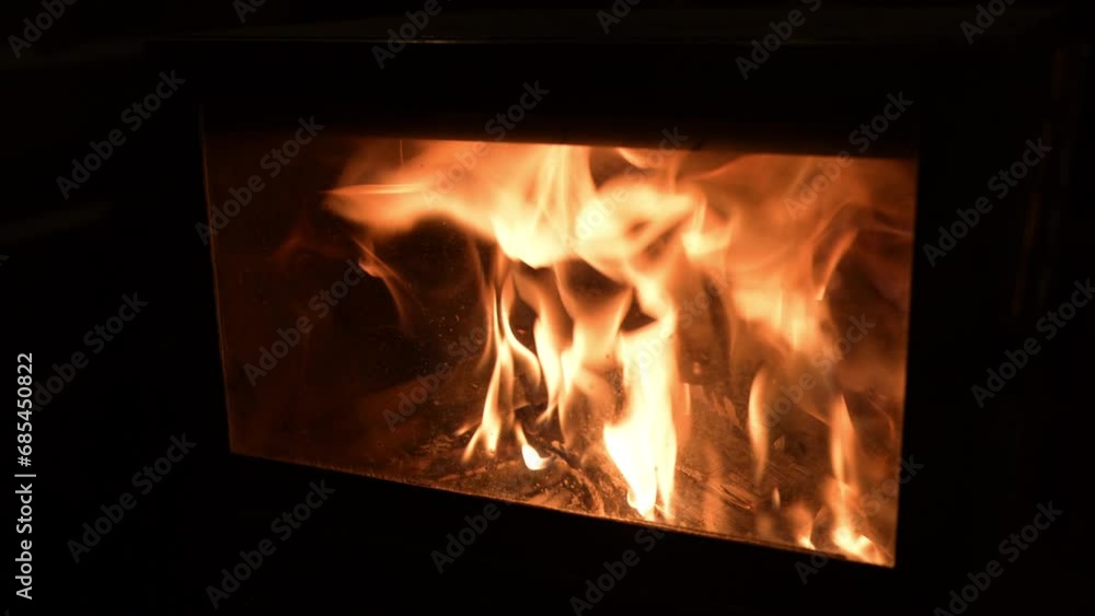 A glowing camp fire providing comfortable lights and barbecue grill pit ...