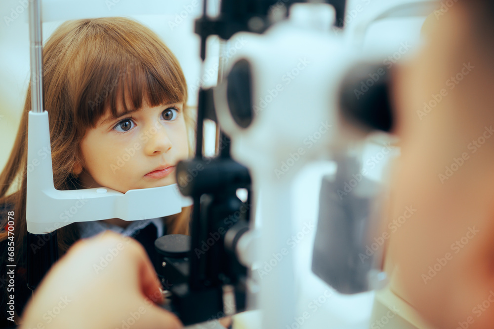 Toddler Girl During Eye Examination with a Slit Lamp Microscope. Little ...
