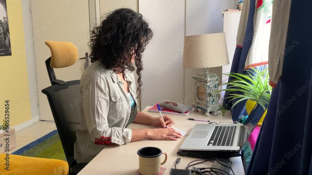 Vidéo Stock A young beautiful Persian girl Iranian woman are working at ...