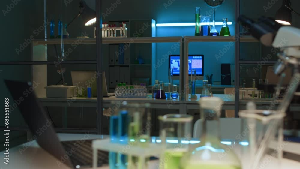 Close-up shot of worktop of scientist at chemical laboratory in dim ...