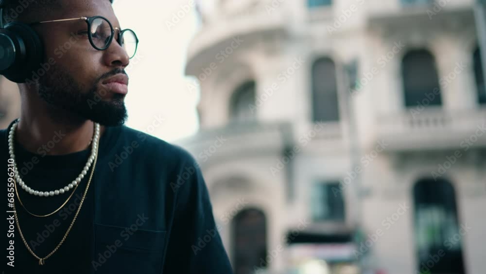 Trendy dressed black male composing his own music or beats inspired by ...
