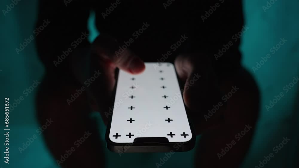 In a Dark Restroom, a Man on the Toilet Is Scrolling Up on a Smartphone ...