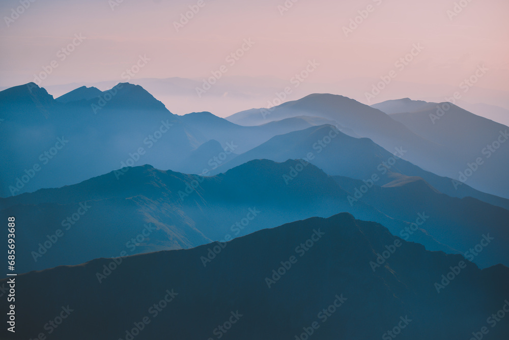 Sharp mountain peaks seen in stunning light from high altitude. Fairy ...