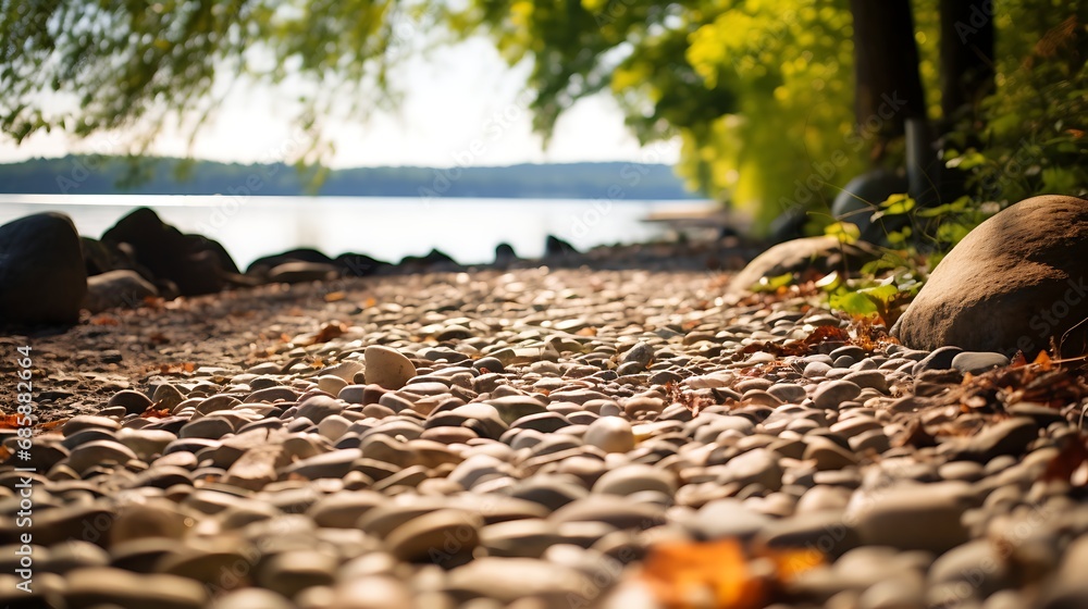 Lovely focus blur of a lakeside pathway in summer, pebbles scattered ...